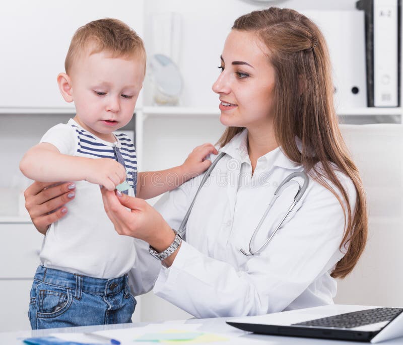 Female Doctor is Examining Kid Stock Image - Image of chair, female ...