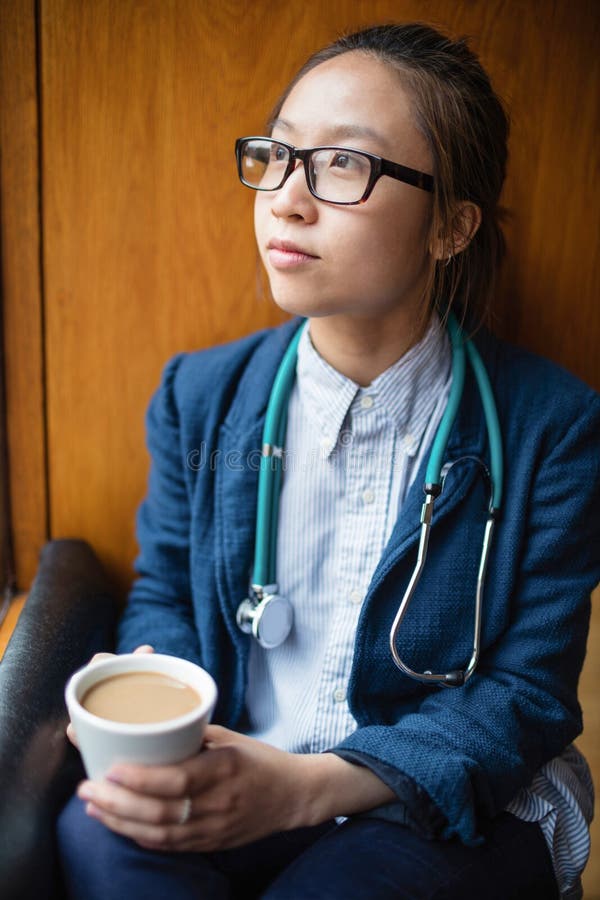 Female Doctor Having Tea in Clinic Stock Image - Image of beverage ...