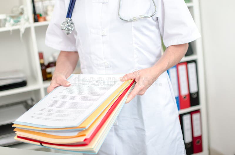 Female Doctor Holding Files Stock Photo - Image of folders, clinic ...