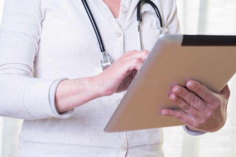 Female Doctor is Holding a Tablet in Her Hand Stock Image - Image of ...