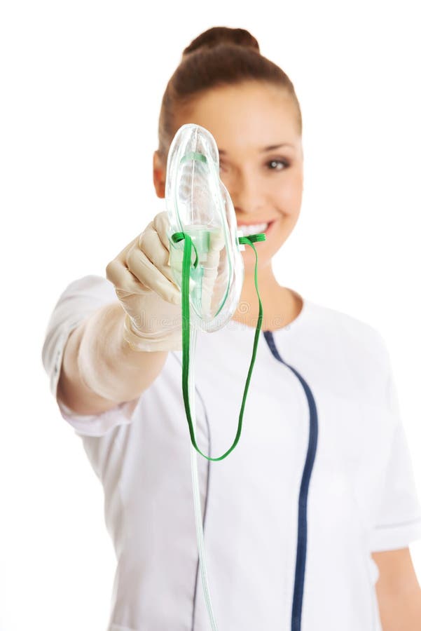 Female Doctor Holding Up Oxygen Mask Stock Photo - Image of breathing ...
