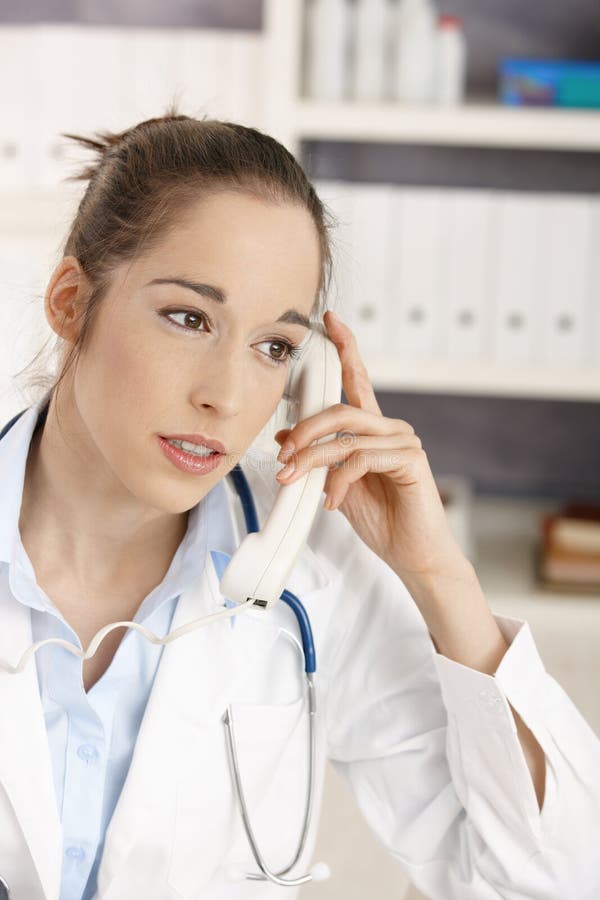 Female doctor on the phone stock image. Image of health - 16313637