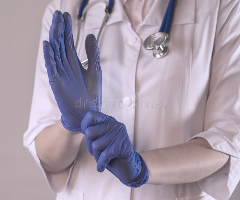 Female Doctor Putting On Protective Rubber Gloves Closeup Hands In