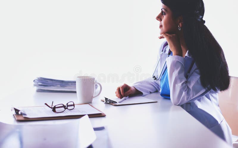 Female Doctor Sitting on the Desk with Paper and Working Stock Photo ...