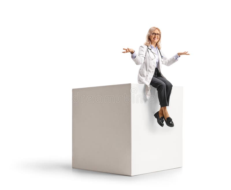 Female Doctor Sitting on a White Cube and Waiting Stock Photo - Image ...