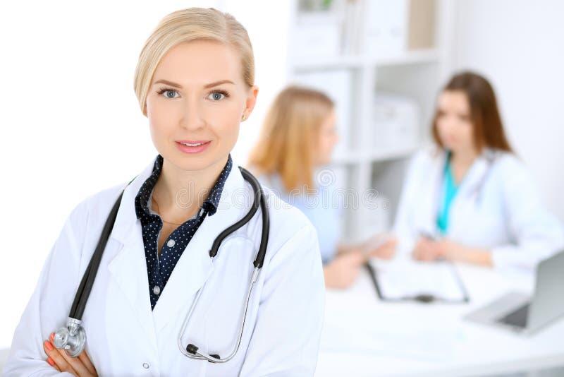 Female Doctor Smiling on the Background with Patient and His Physician ...