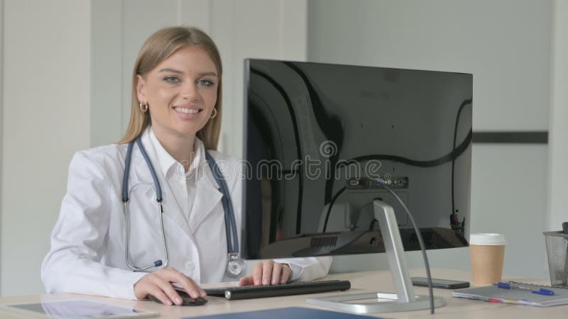 Female Doctor Smiling at Camera at Work in Clinic Stock Footage - Video ...