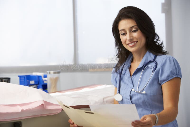 Female Doctor in Surgery Reading Patient Notes Stock Photo - Image of ...
