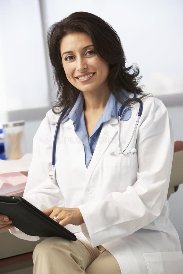 Female Doctor in Surgery Reading Patient Notes Stock Image - Image of ...