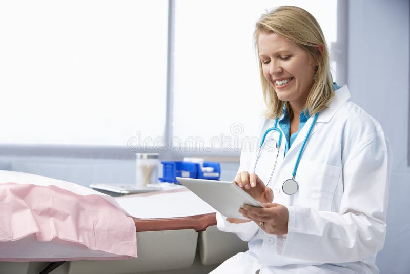 Female Doctor in Surgery Using Digital Tablet Stock Image - Image of ...