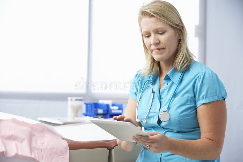 Female Doctor in Surgery Using Digital Tablet Stock Photo - Image of ...