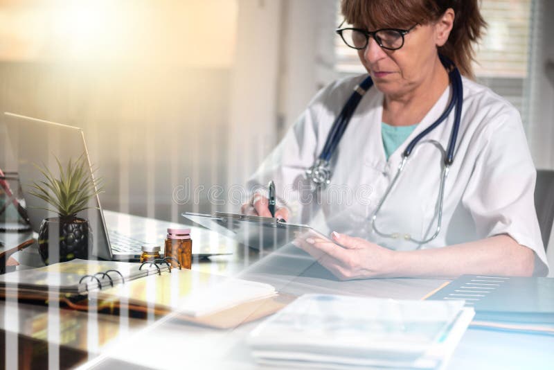 Female Doctor Taking Notes on Clipboard; Multiple Exposure Stock Image ...