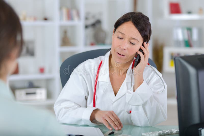 Female Doctor Talking on Phone Stock Image - Image of pretty, doctor ...