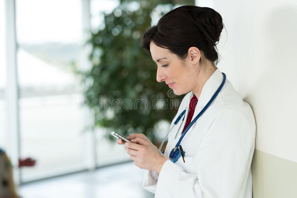 Female Doctor Texting on Smartphone Stock Photo - Image of office ...