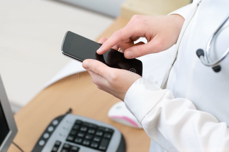 Doctor Texting on a Cell Phone Stock Image - Image of facial, doctor ...