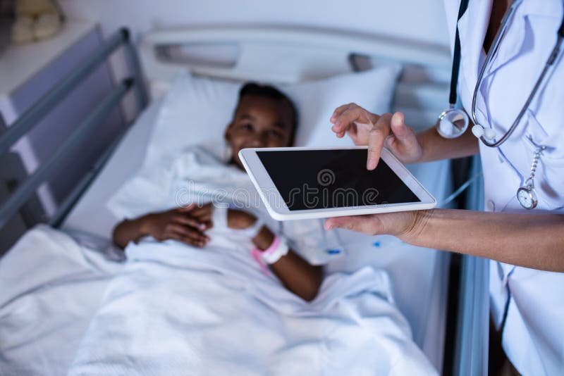 Female Doctor Using Digital Tablet during Visit in Ward Stock Image ...