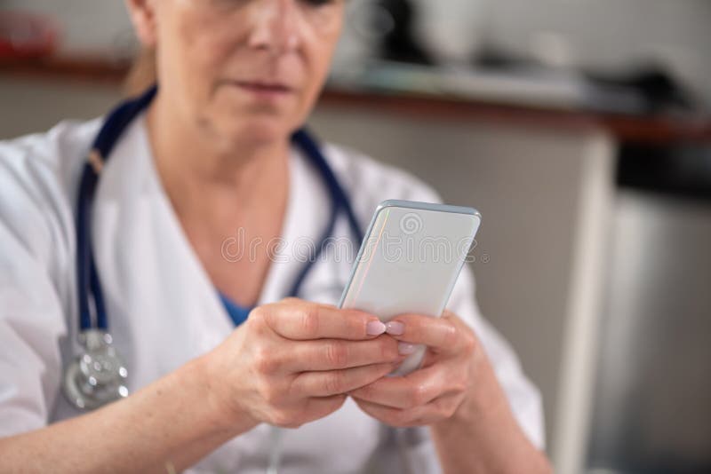 Female Doctor Using Her Mobile Phone Stock Photo - Image of healthcare ...
