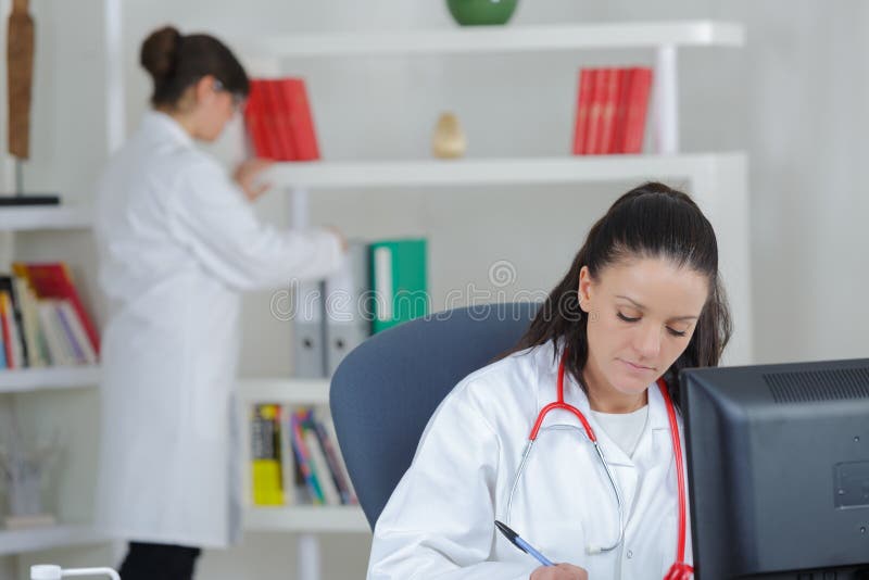 Female Doctor Using Laptop Computer at Clinic Stock Image - Image of ...