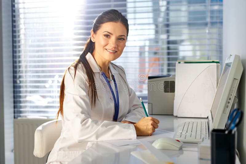 Female Doctor Using Pc Computer while Sitting at Work Place, Posing at ...