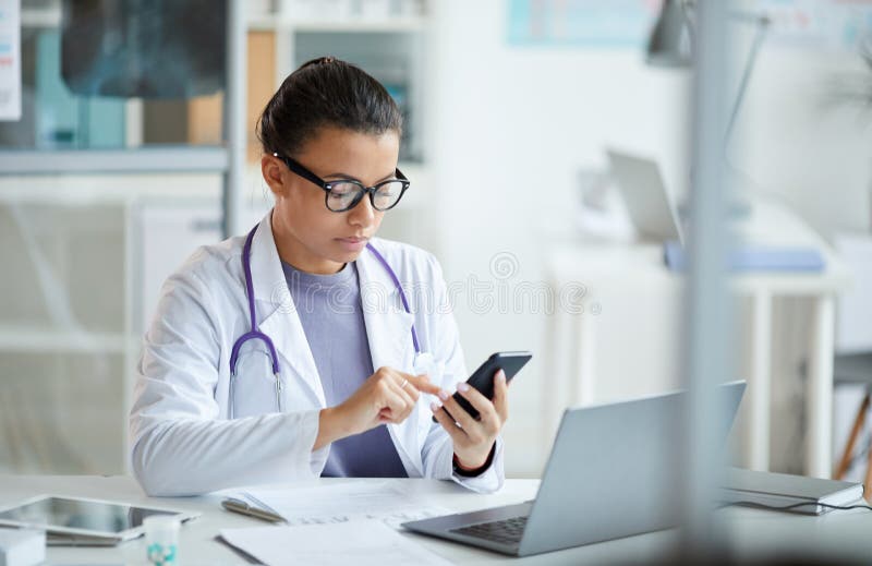 Female Doctor Using Phone in Her Work Stock Photo - Image of computer ...