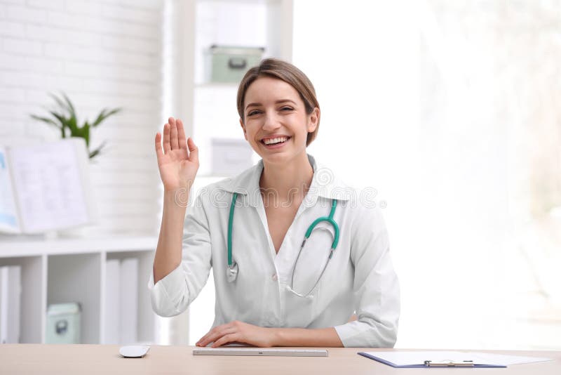 Female Doctor Using Video Chat at Workplace Stock Image - Image of ...