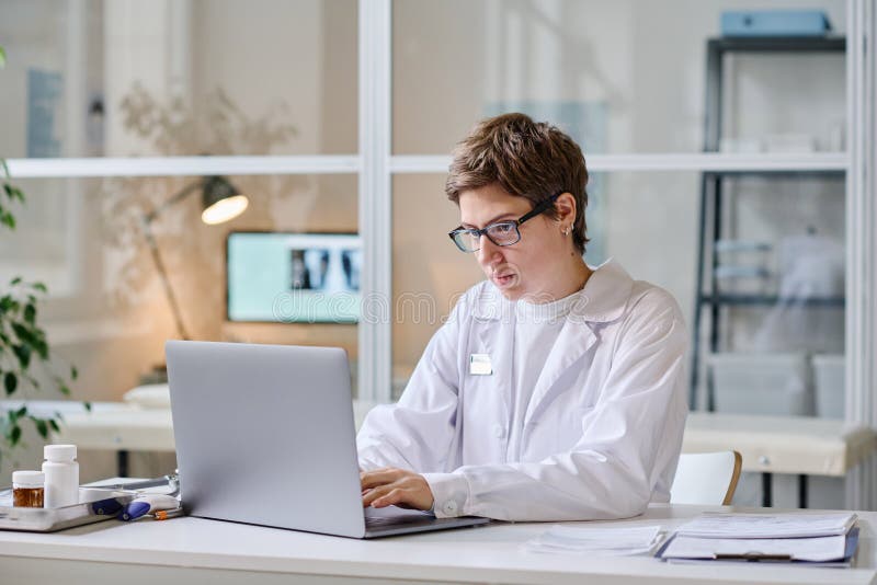 Female Doctor Working on Laptop at Office Stock Image - Image of ...