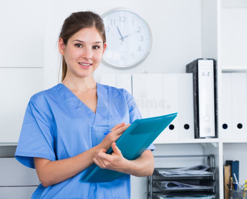 Female Doctor Writing Notes in Clinic Stock Image - Image of office ...
