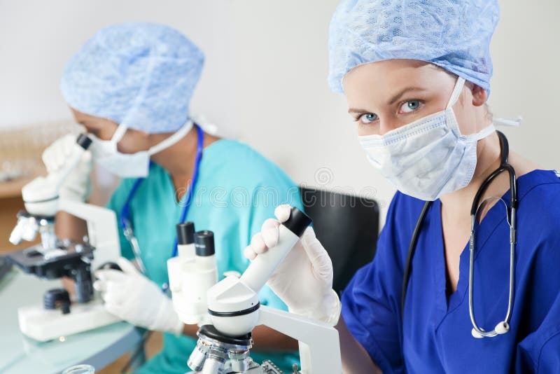 Female Doctors Using Microscopes in a Laboratory Stock Photo - Image of ...