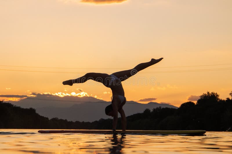 Female Doing Yoga Exercise on the Beach at Sunset Stock Photo - Image ...