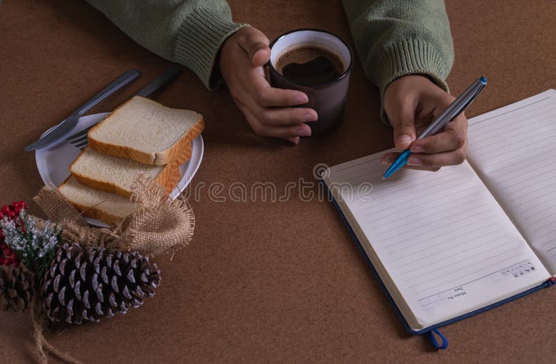 Female Drinking Coffee and Writing Down Her Ideas in a Planner Stock ...