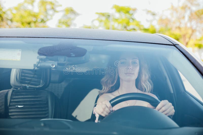 Female Driver Driving Behind the Wheel of a White Car Stock Photo ...