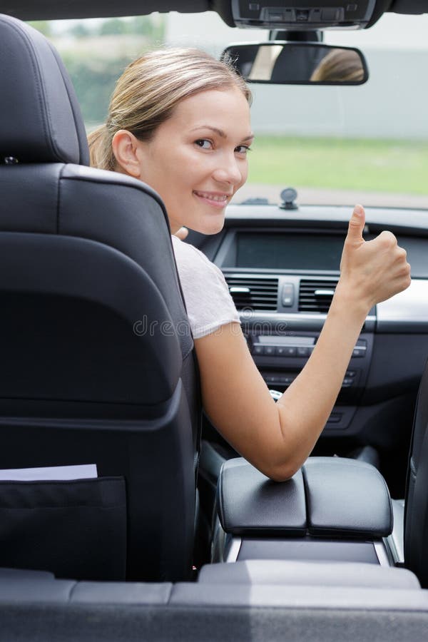 Female Driver Turning To Back and Making Thumbs Up Gesture Stock Photo ...