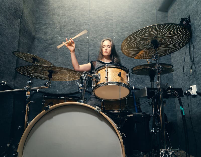 Female Drummer Playing Drums in Professional Studio. Focused Expression ...