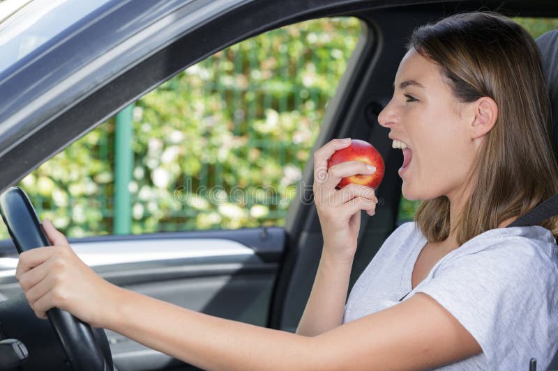 Female Eating Apple Inside Car Stock Photo - Image of unseen, eating ...