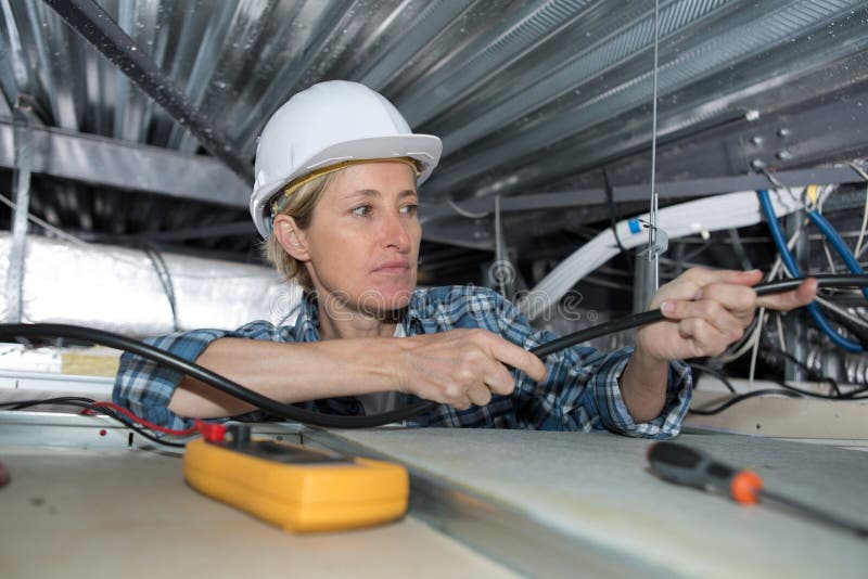 Female Electrician with Cables Stock Photo - Image of installing ...