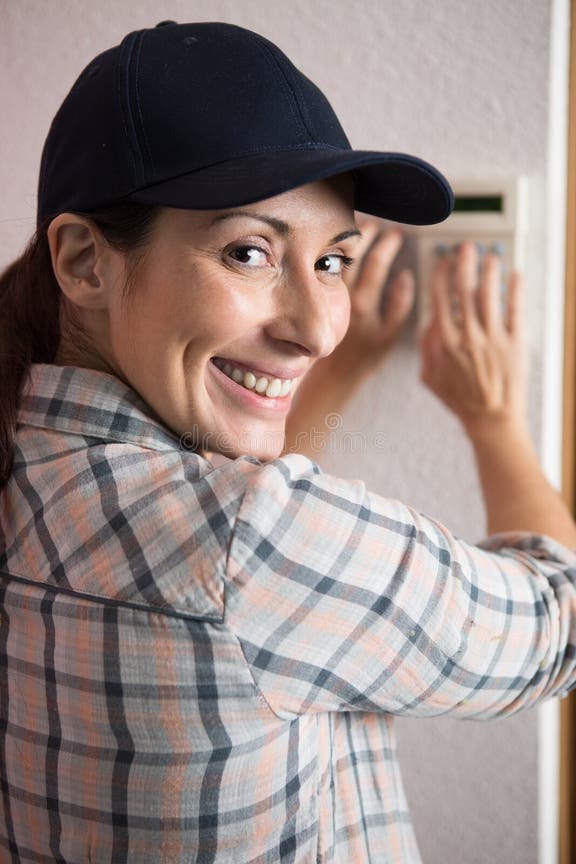 Female Electrician Installing Intercom Stock Photo - Image of electrical, craftsman: 263373736