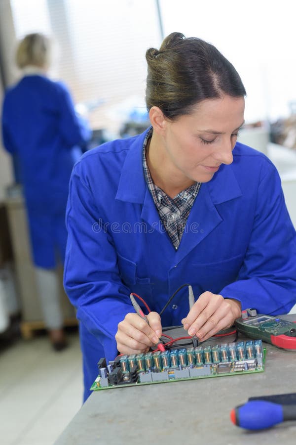 Female Electrician Measuring Voltage in Distribution Board Closeup ...
