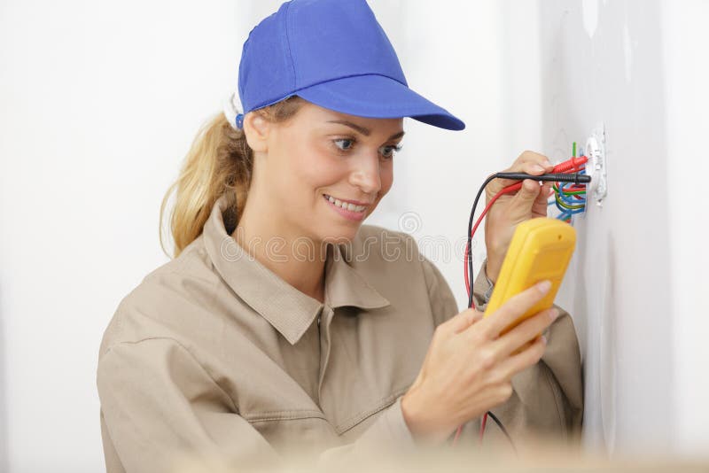 Female Electrician Testing Socket Using Multimeter Stock Photo - Image ...