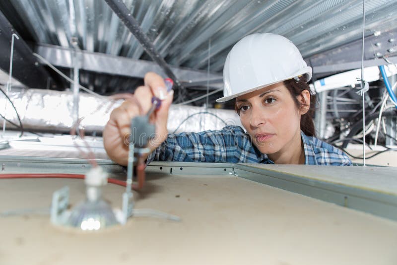 Female Electrician Working on Spotlamp from Above Stock Photo - Image ...