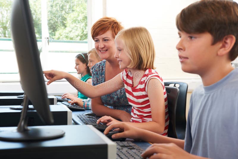 Female Elementary Pupil in Computer Class with Teacher Stock Photo ...