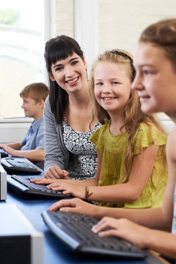 Portrait of Female Elementary Pupil in Computer Class with Teach Stock ...