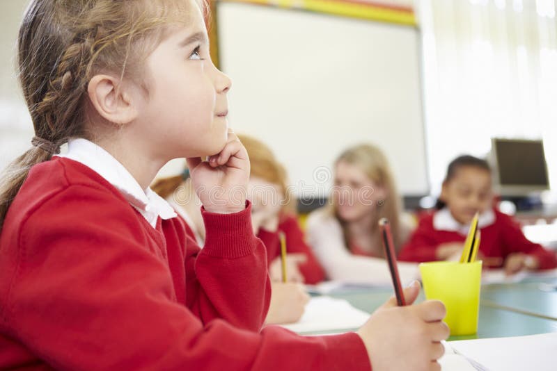 Elementary Pupil Reading with Teacher in Classroom Stock Image - Image ...