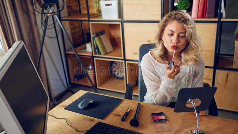 Female Employee Applies Makeup at Her Desk. she S Distracted from Her ...