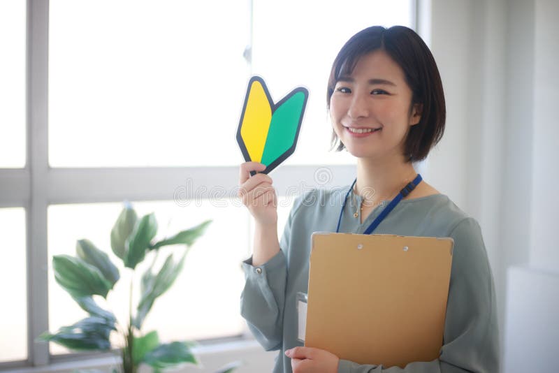 Female Employee with Beginner Mark and Binder Stock Photo - Image of ...
