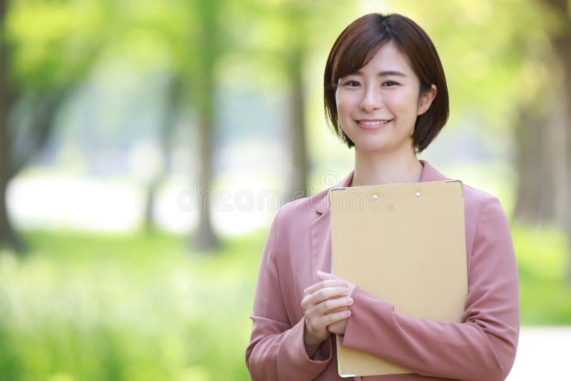 Female Employee with a Binder Stock Image - Image of purple, worker ...