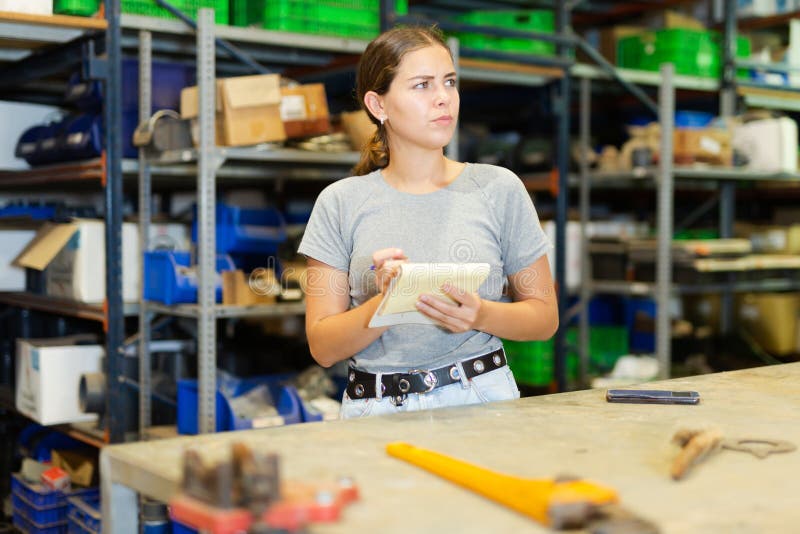 Female Employee of Hardware Store Makes Notes in a Notebook Stock Photo ...