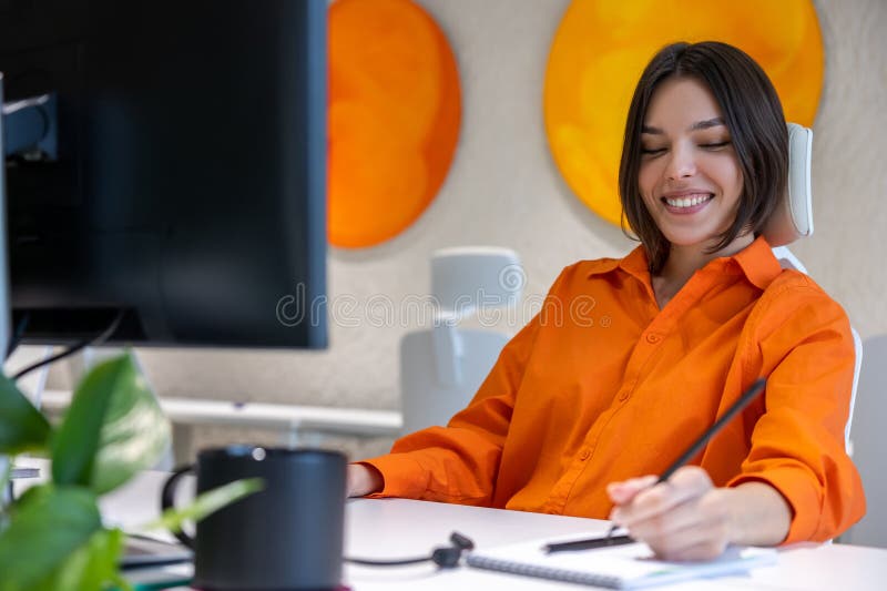 Female Employee Making Notes in Her Notebook in the Office Stock Photo ...