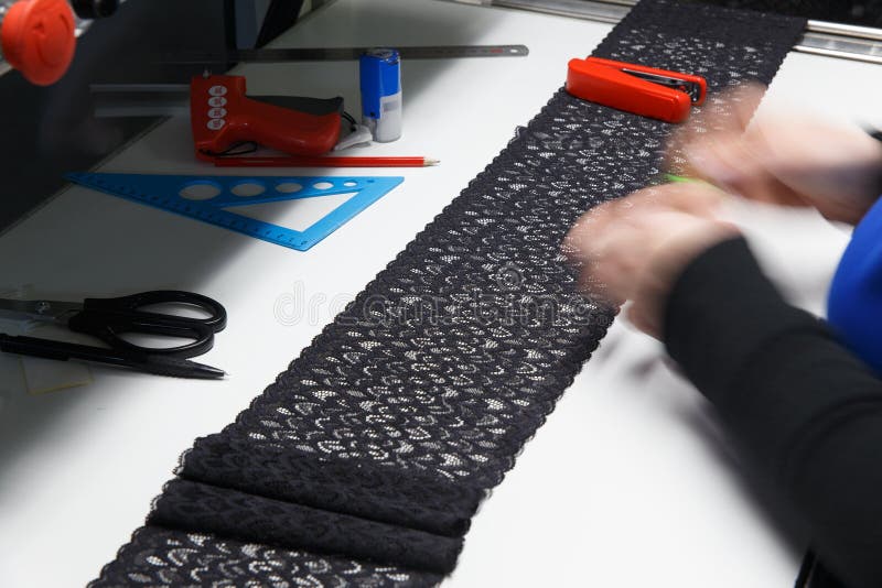 A Female Employee Performs Visual Quality Control of the Lace Ribbon ...