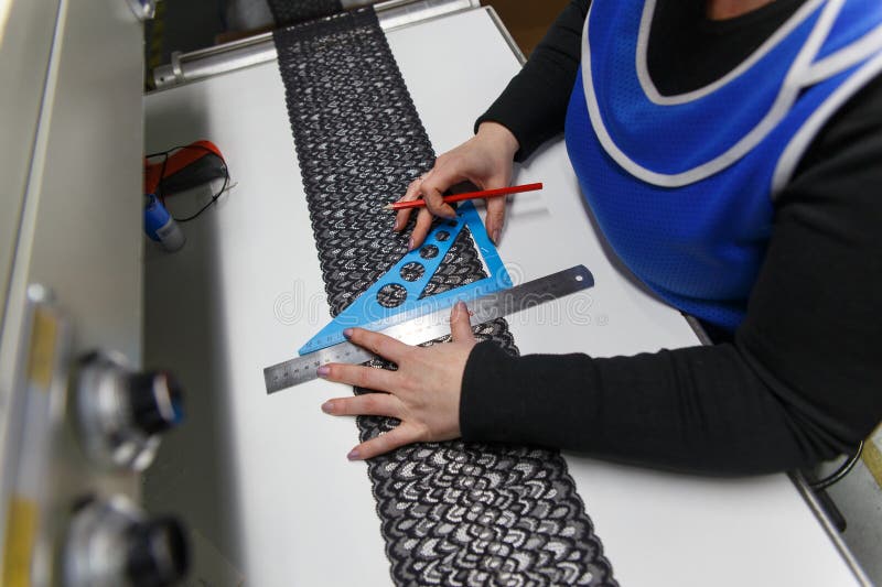 A Female Employee Performs Visual Quality Control of the Lace Ribbon ...