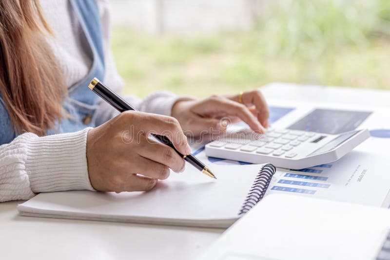 Female Employee is Taking Notes and Pressing a Calculator. Stock Photo ...